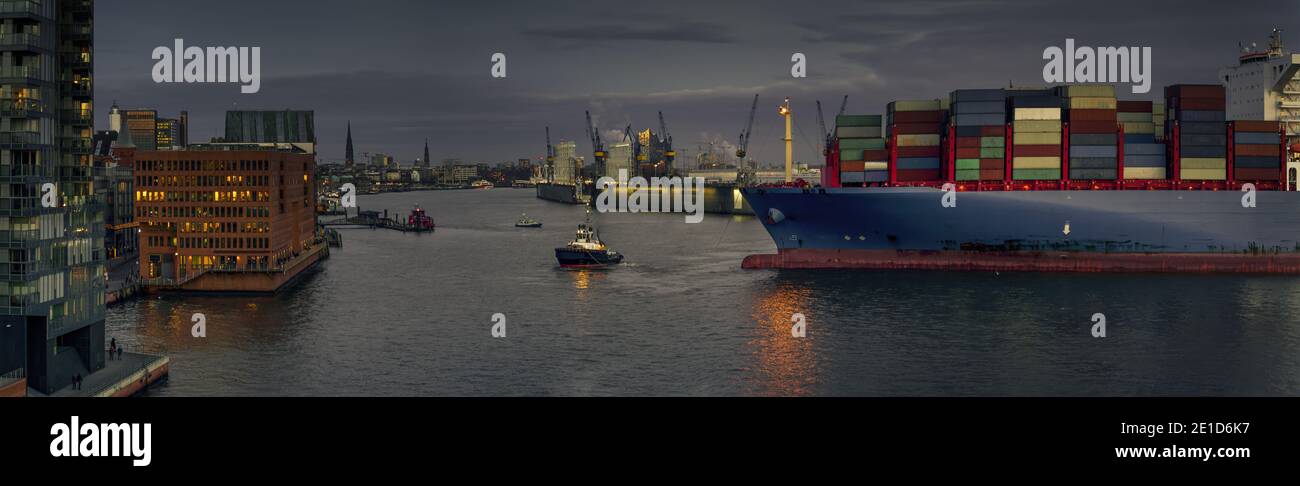 large container ship during a turning maneuver in the port of Hamburg ...