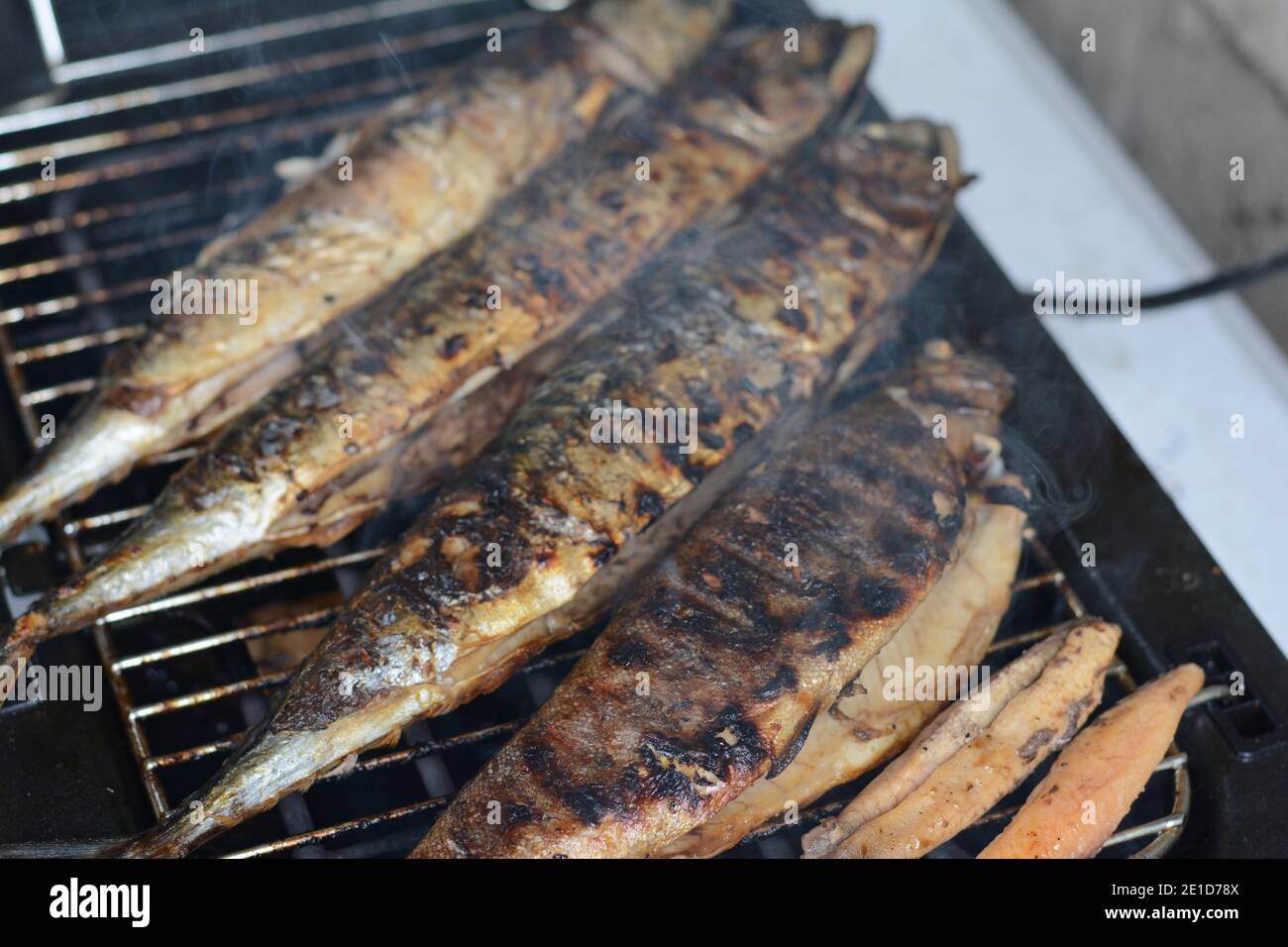 Barbecue with fish. Grilled mackerel fish. Fatty, oily fish is an ...