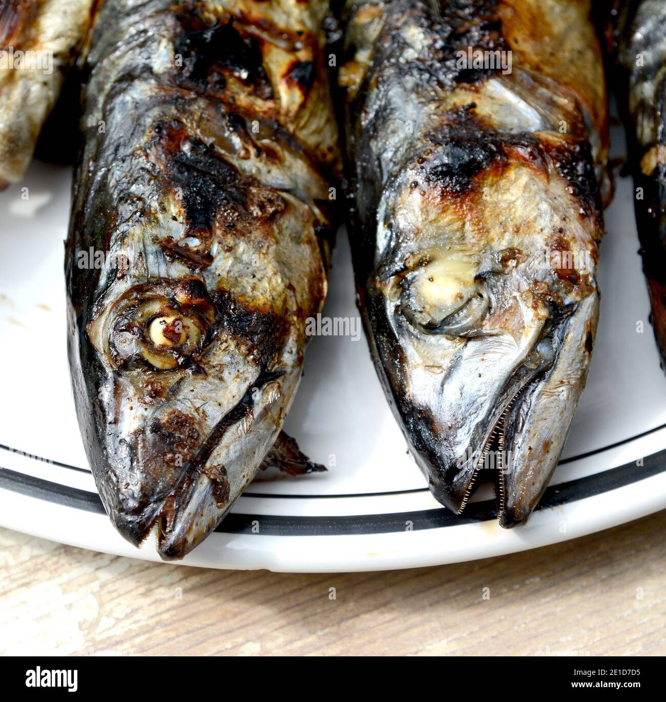 Grilled Mackerel fish on a white plate. Fatty, oily fish is an ...