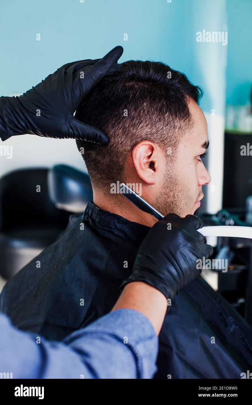 Latin man client getting haircut by hairdresser in Mexico city Stock ...