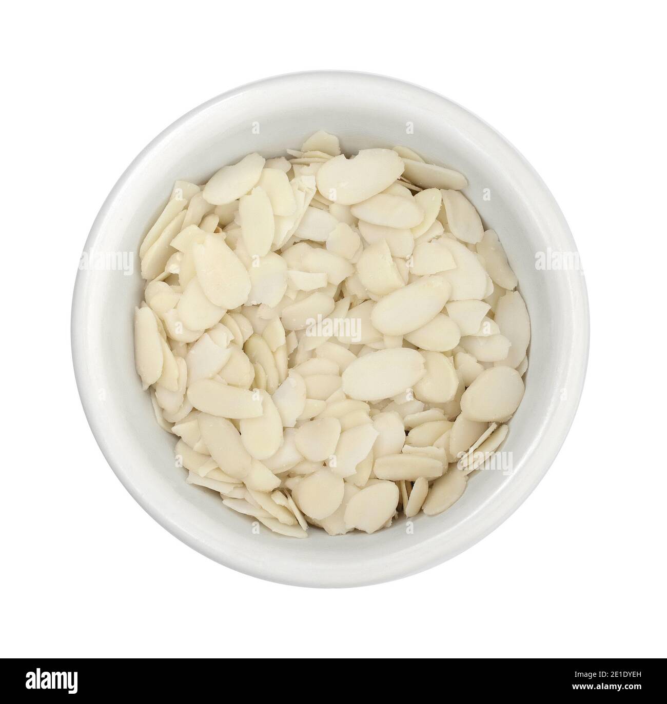 Pile of peeled flaked almonds in a bowl isolated on white. Blanched ...