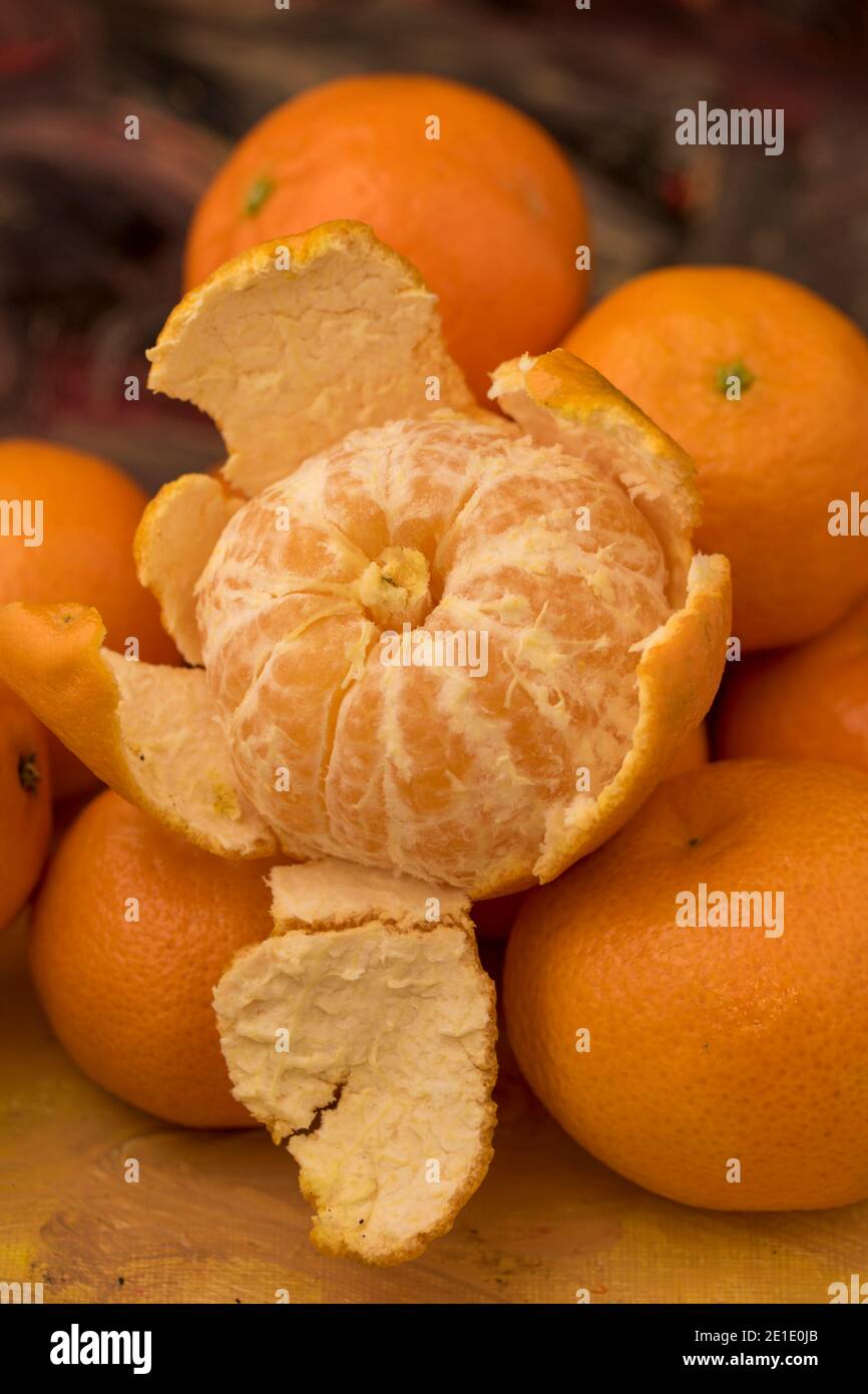 Part peeled tangerine showing pattern, texture and pith, food ...
