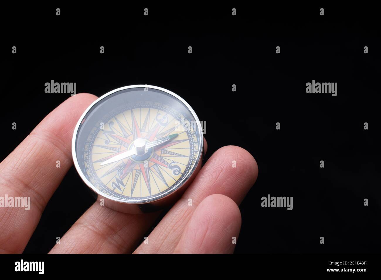 Compass tool in hand o as travel concept Stock Photo - Alamy