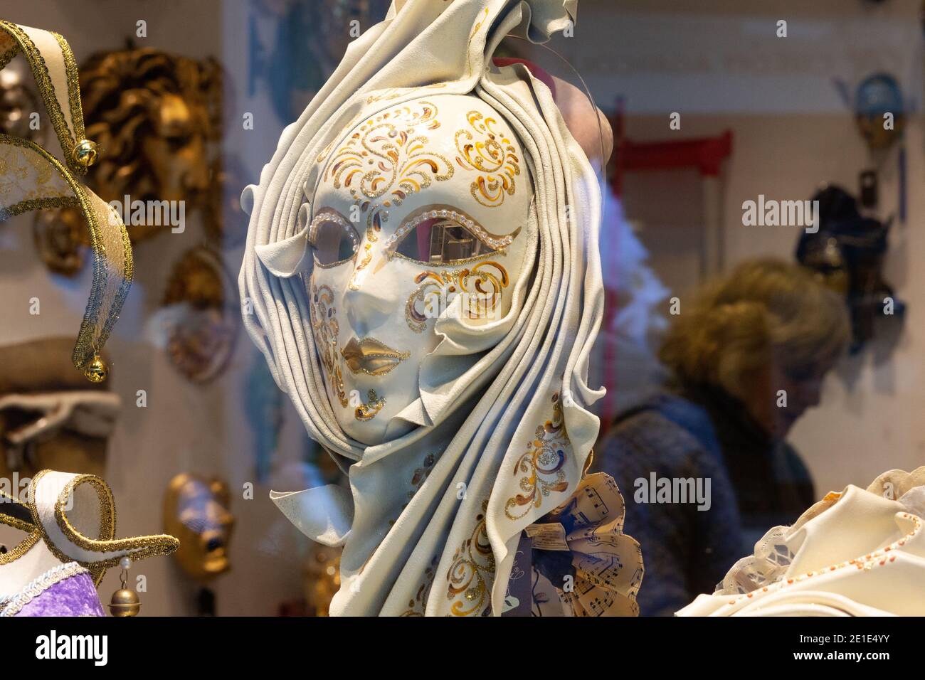 Traditional venetian mask white and gold and lether in store on a ...