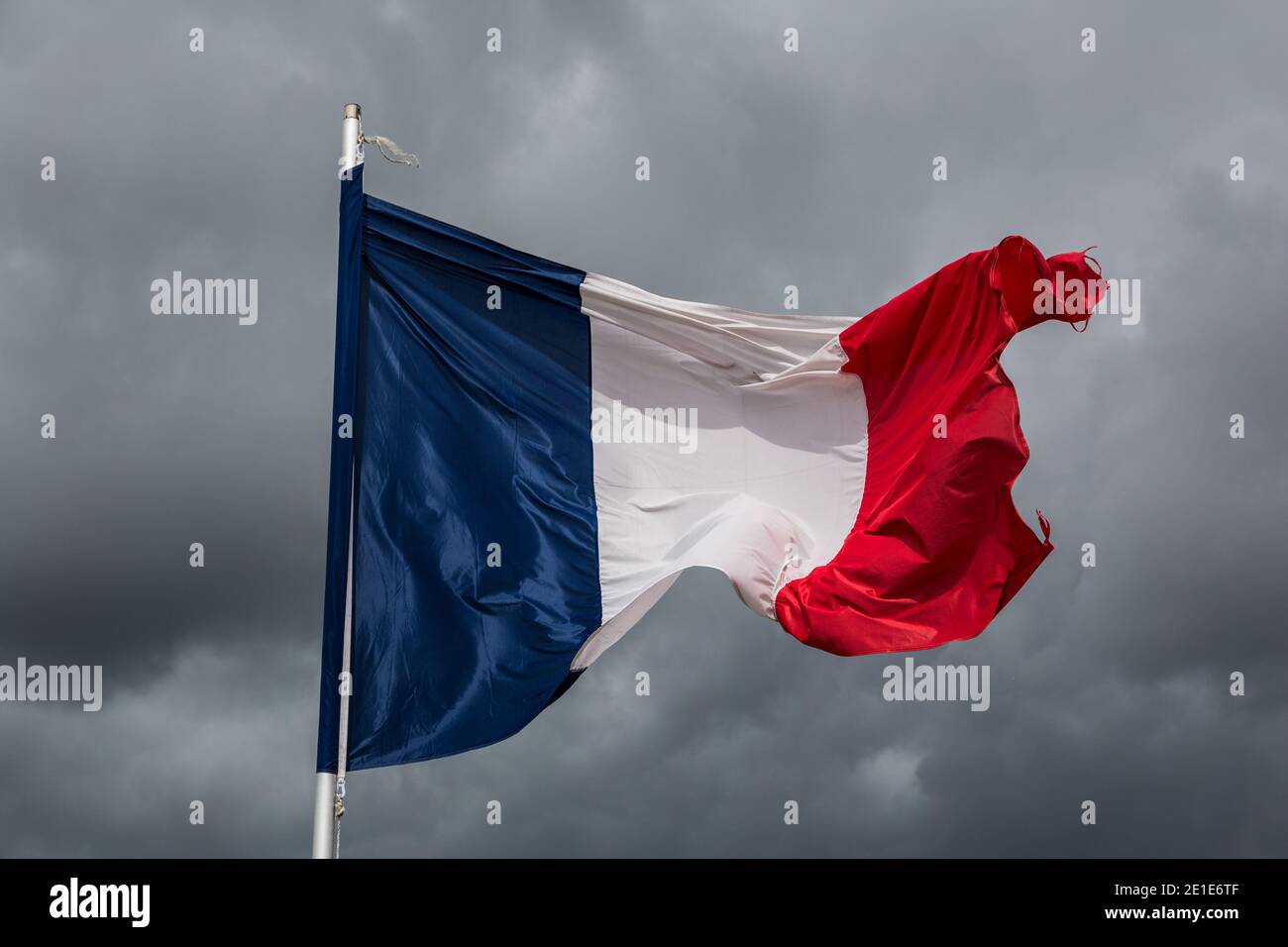 The French national flag against a stormy sky Stock Photo - Alamy