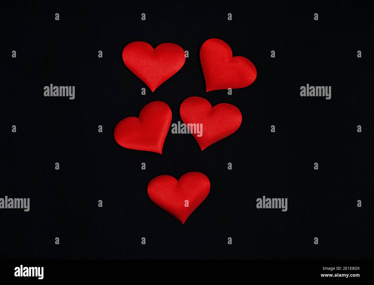 St. Valentines Day concept. Top view of red hearts spread on a black ...