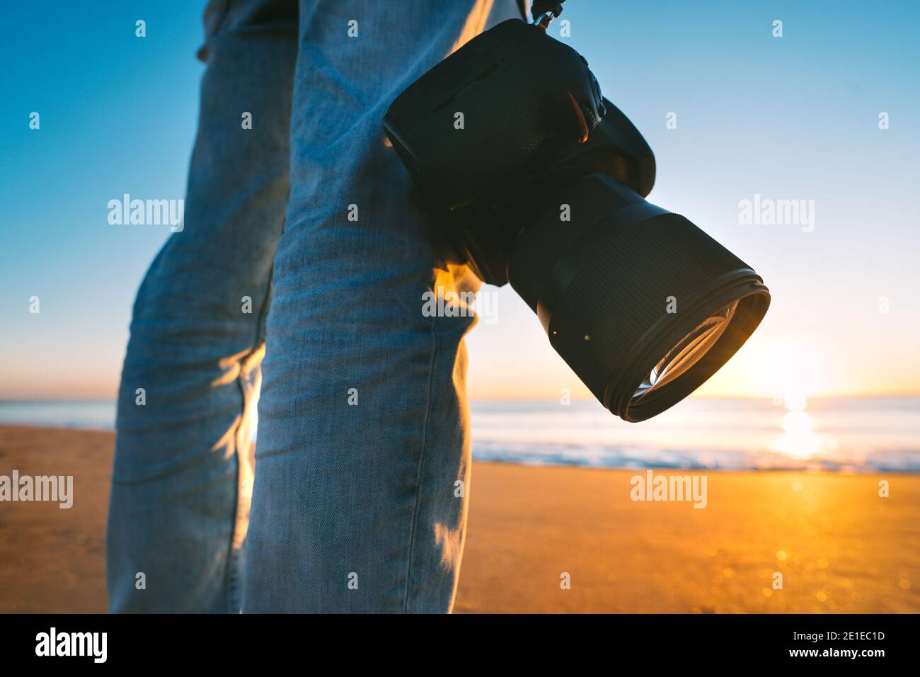 Photographer with his camera on the beach. Sunset photography Stock ...