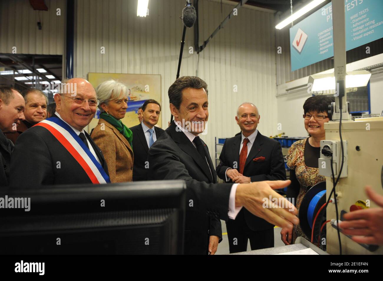 French President Nicolas Sarkozy flanked by Axon’Cable’s CEO Joseph ...