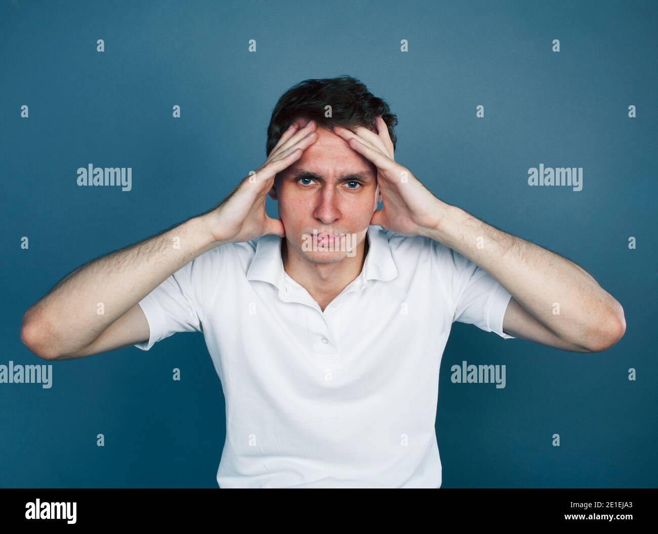 young goofy man with pimples pointing gesturing in studio, stupid ...