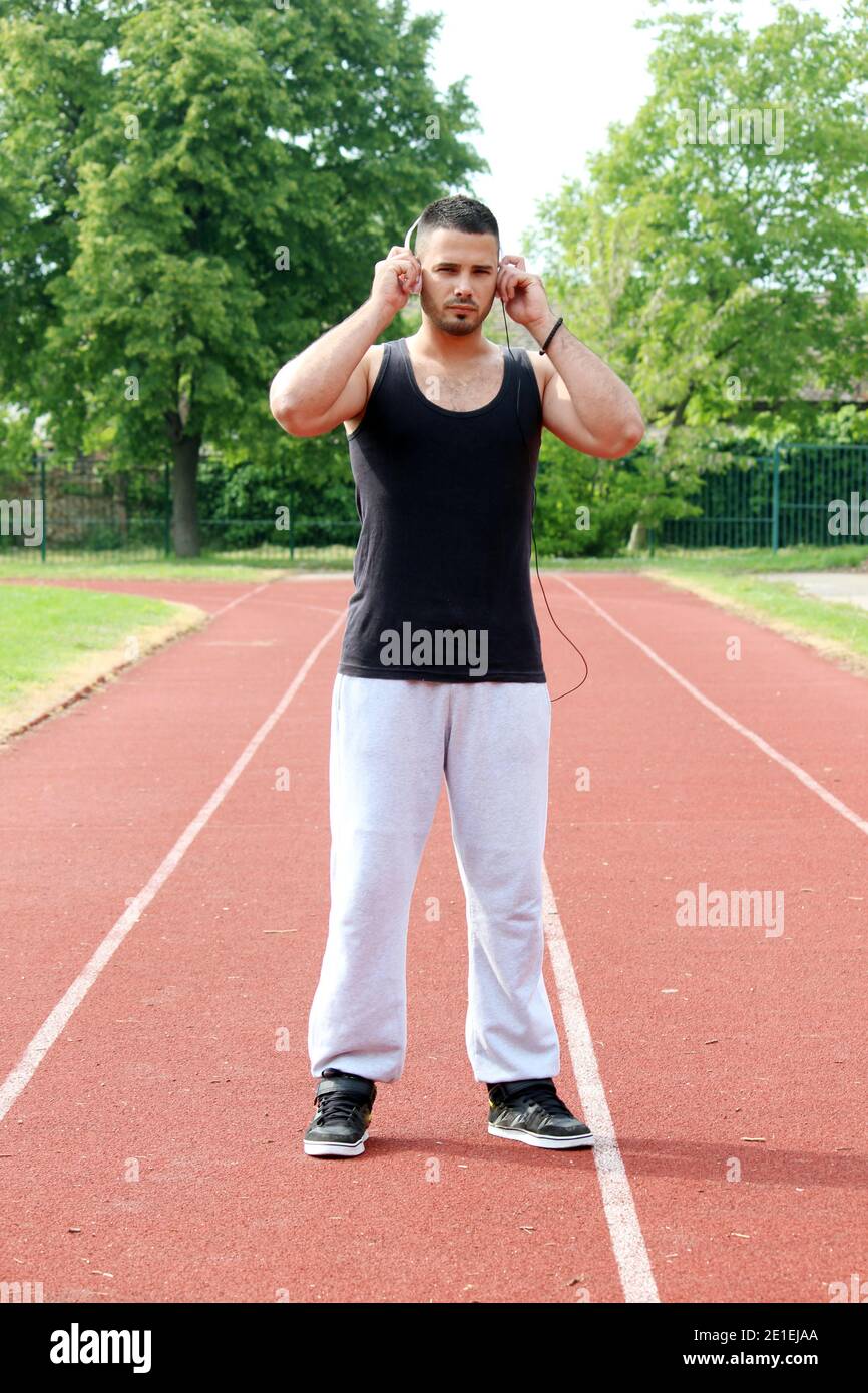 young strong man stretching Stock Photo - Alamy