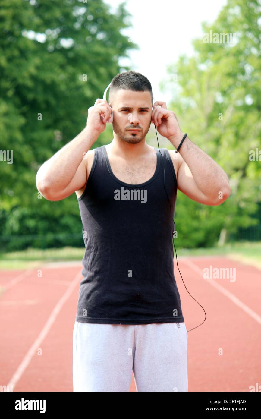 young strong man stretching Stock Photo - Alamy