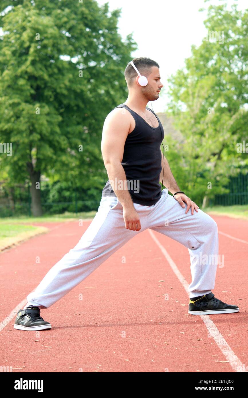 young strong man stretching Stock Photo - Alamy