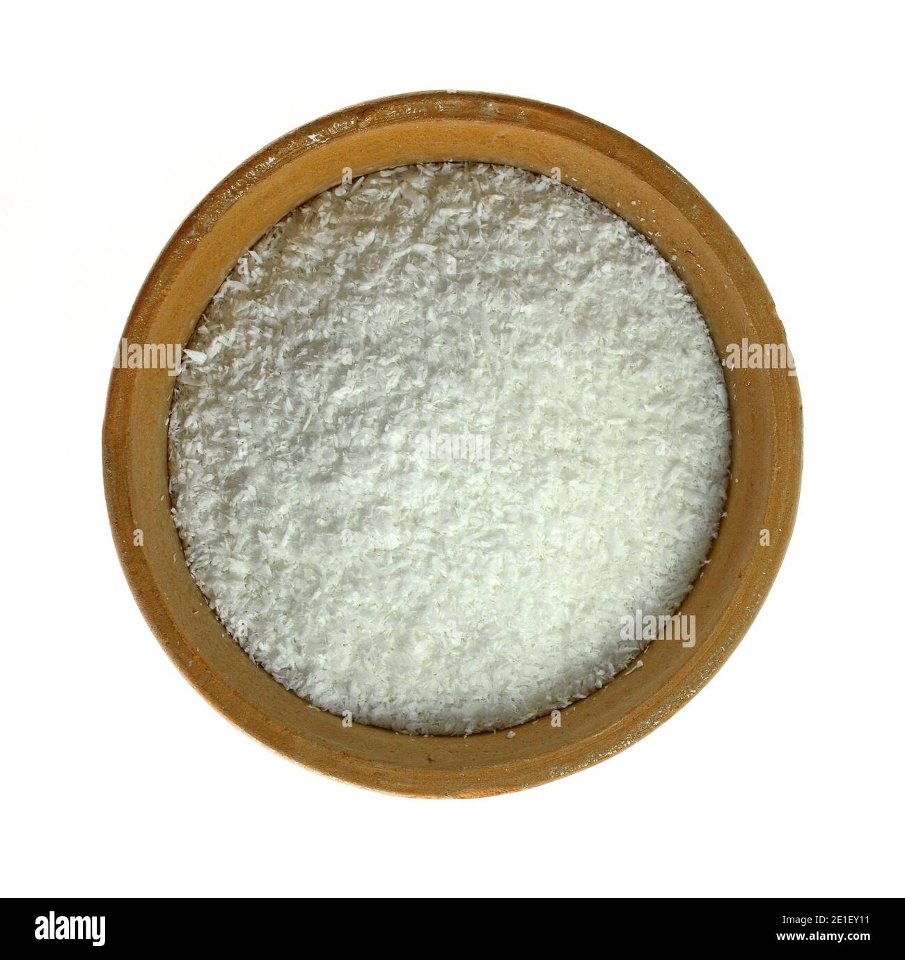 Dessicated coconut in clay bowl isolated on white background Stock ...