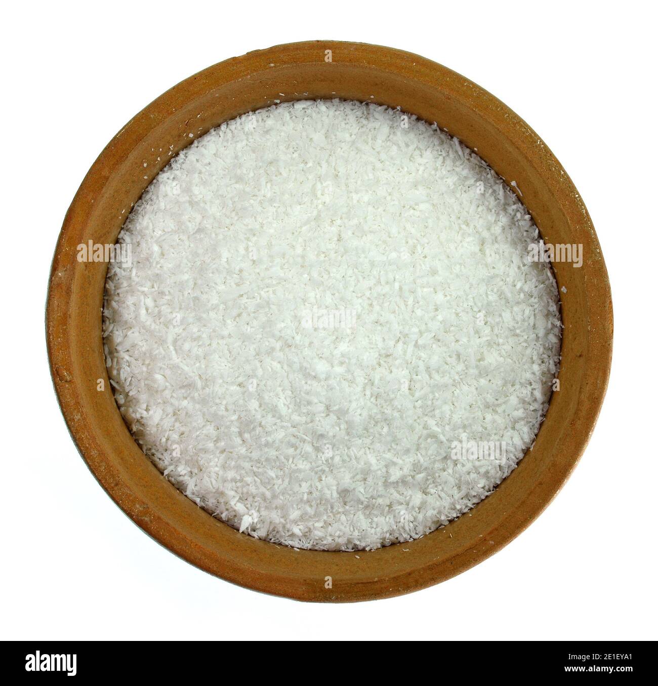 Dessicated coconut in clay bowl isolated on white background Stock ...