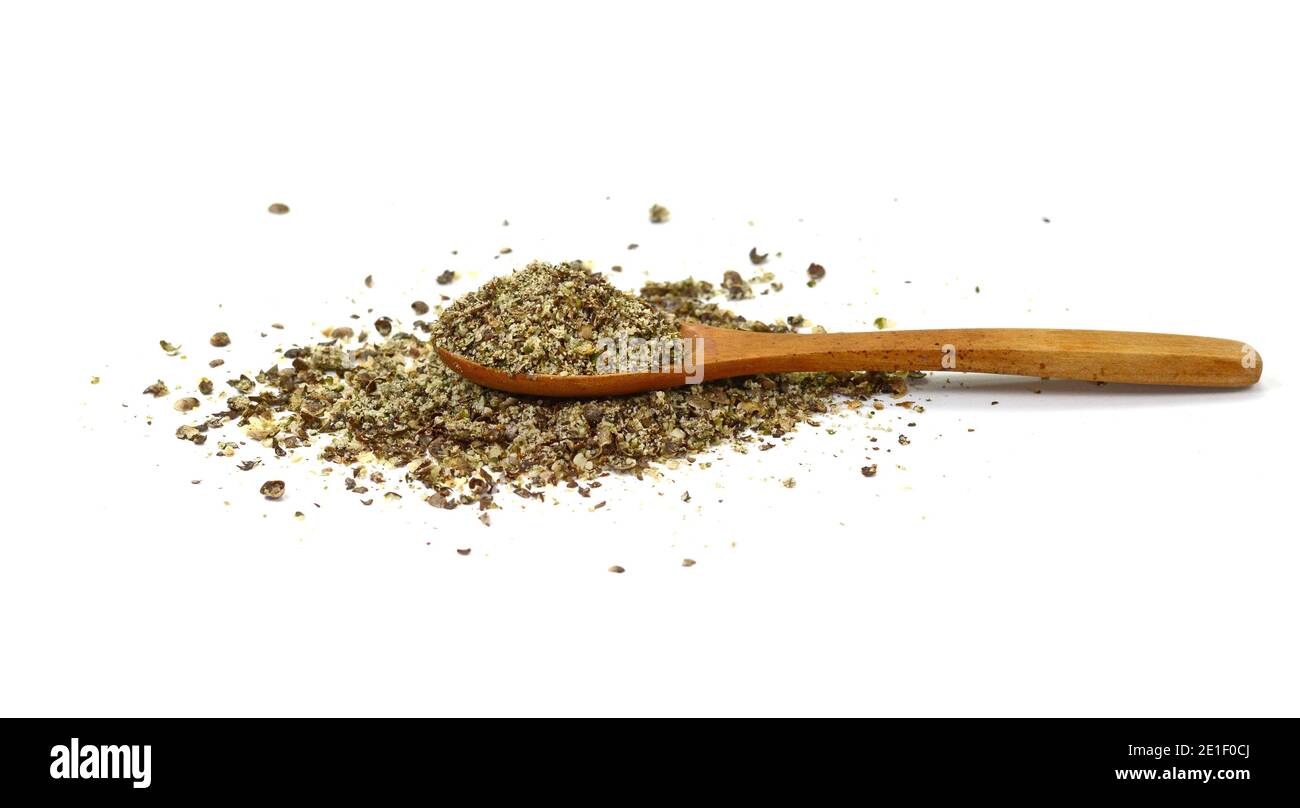 Ground hemp seed in a wooden spoon isolated on white background. Hemp ...
