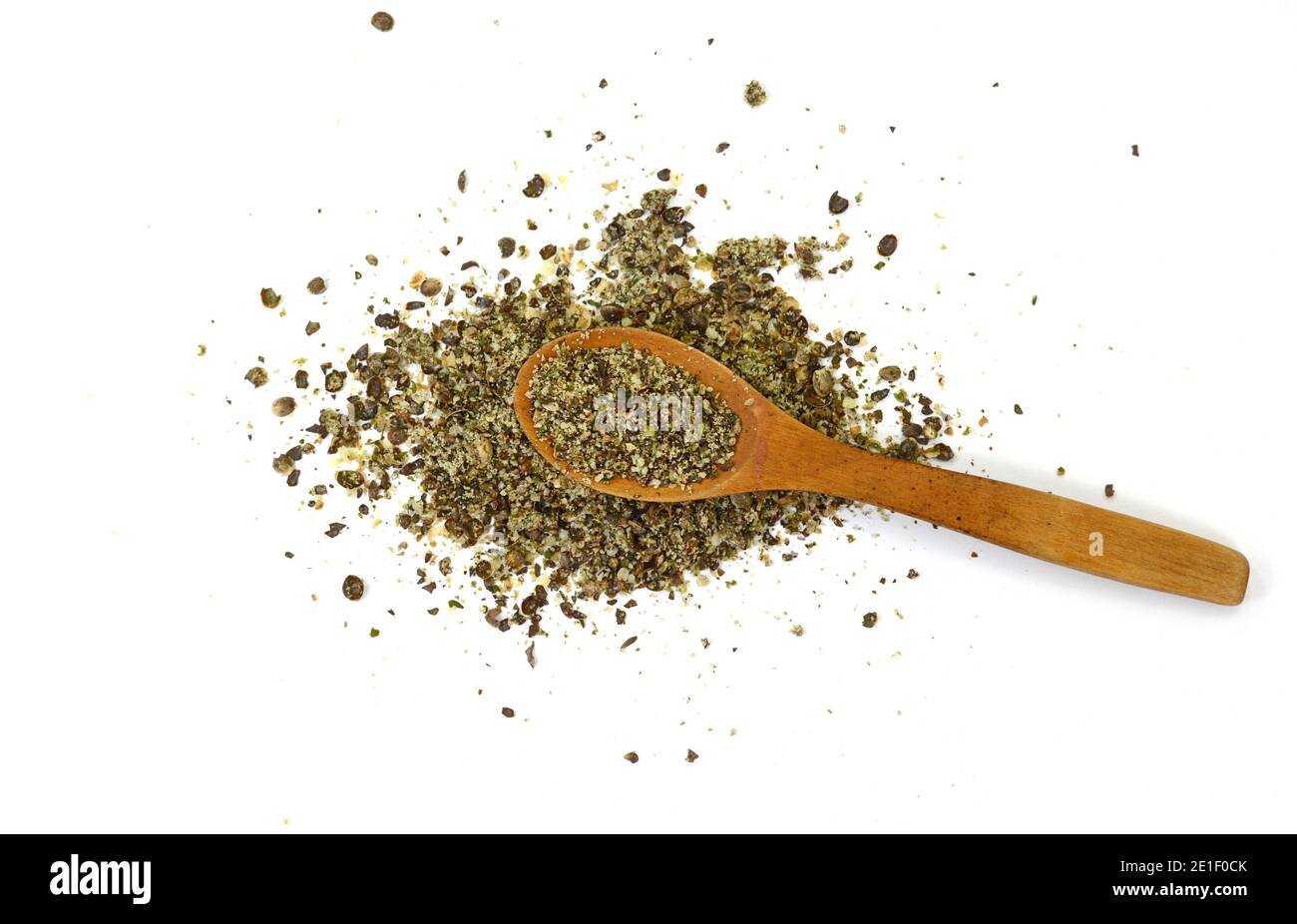 Ground hemp seed in a wooden spoon isolated on white background. Hemp ...