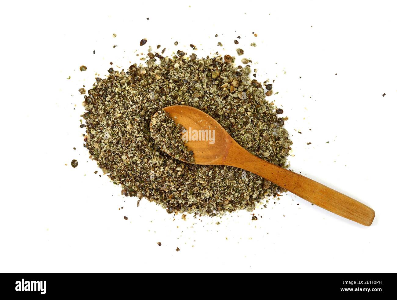 Ground hemp seed in a wooden spoon isolated on white background. Hemp ...