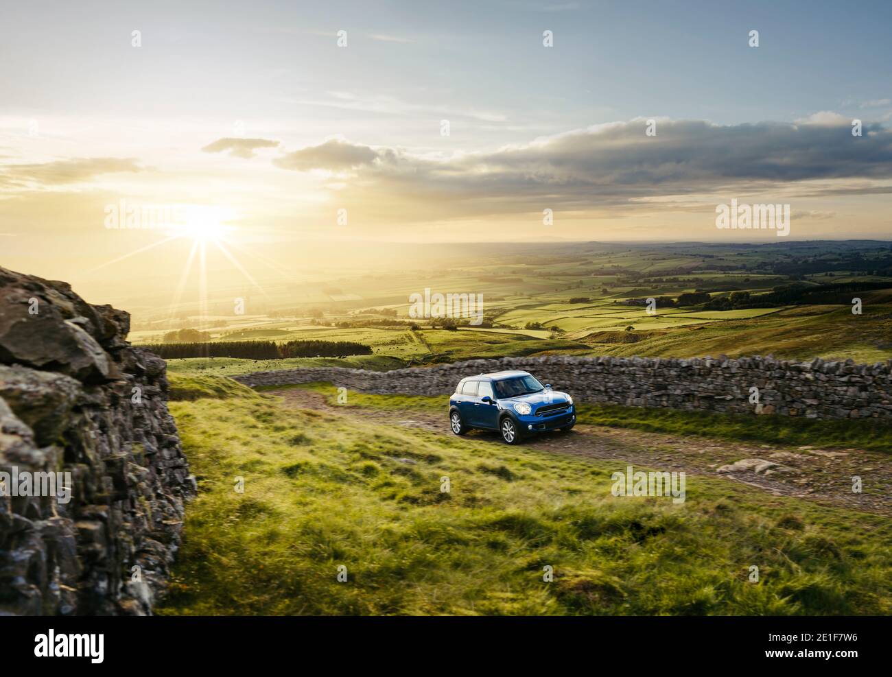 Car driving down english countryside road with view of rolling h Stock ...