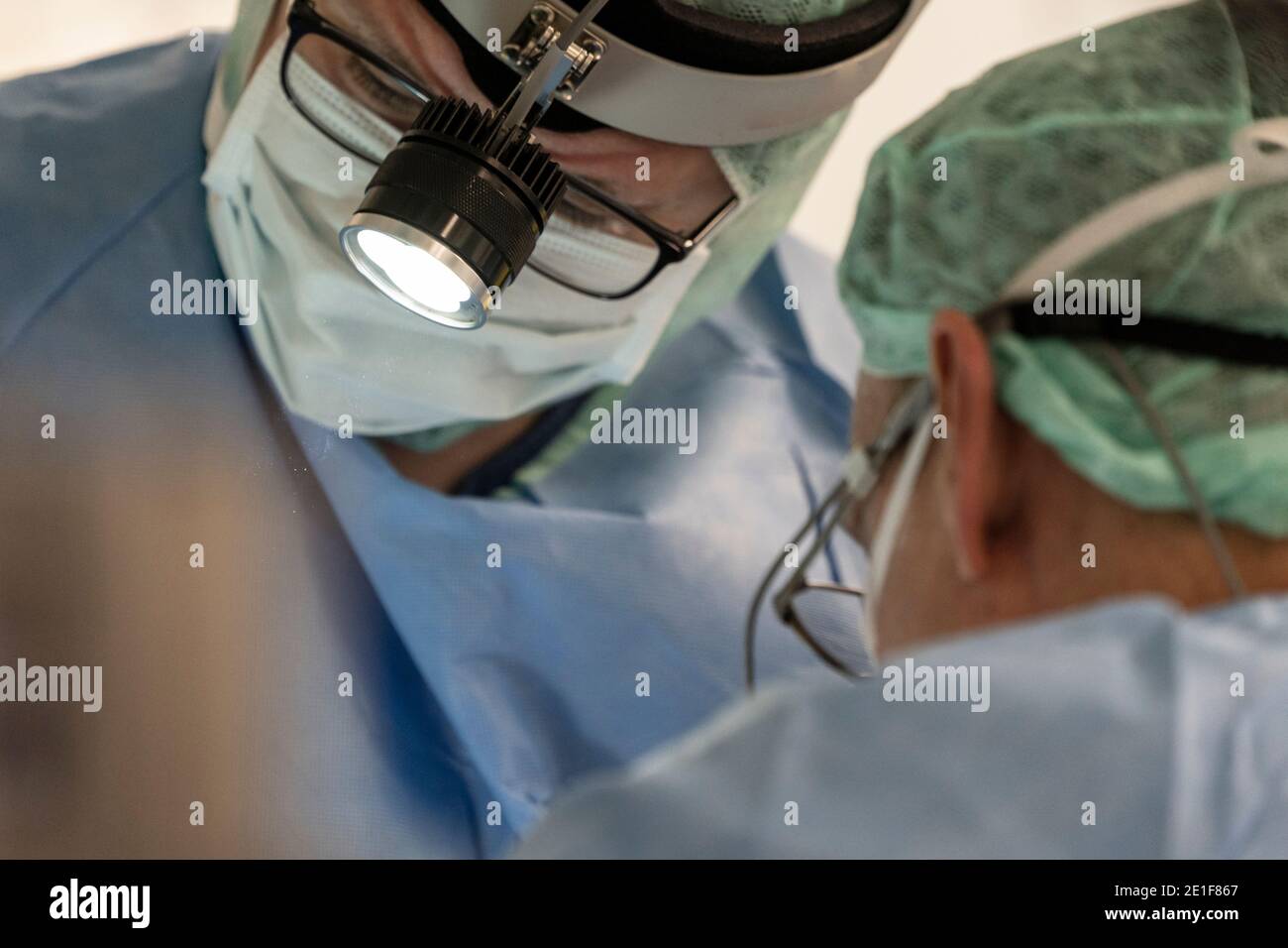 face of a surgeon with a headlamp during surgery Stock Photo - Alamy