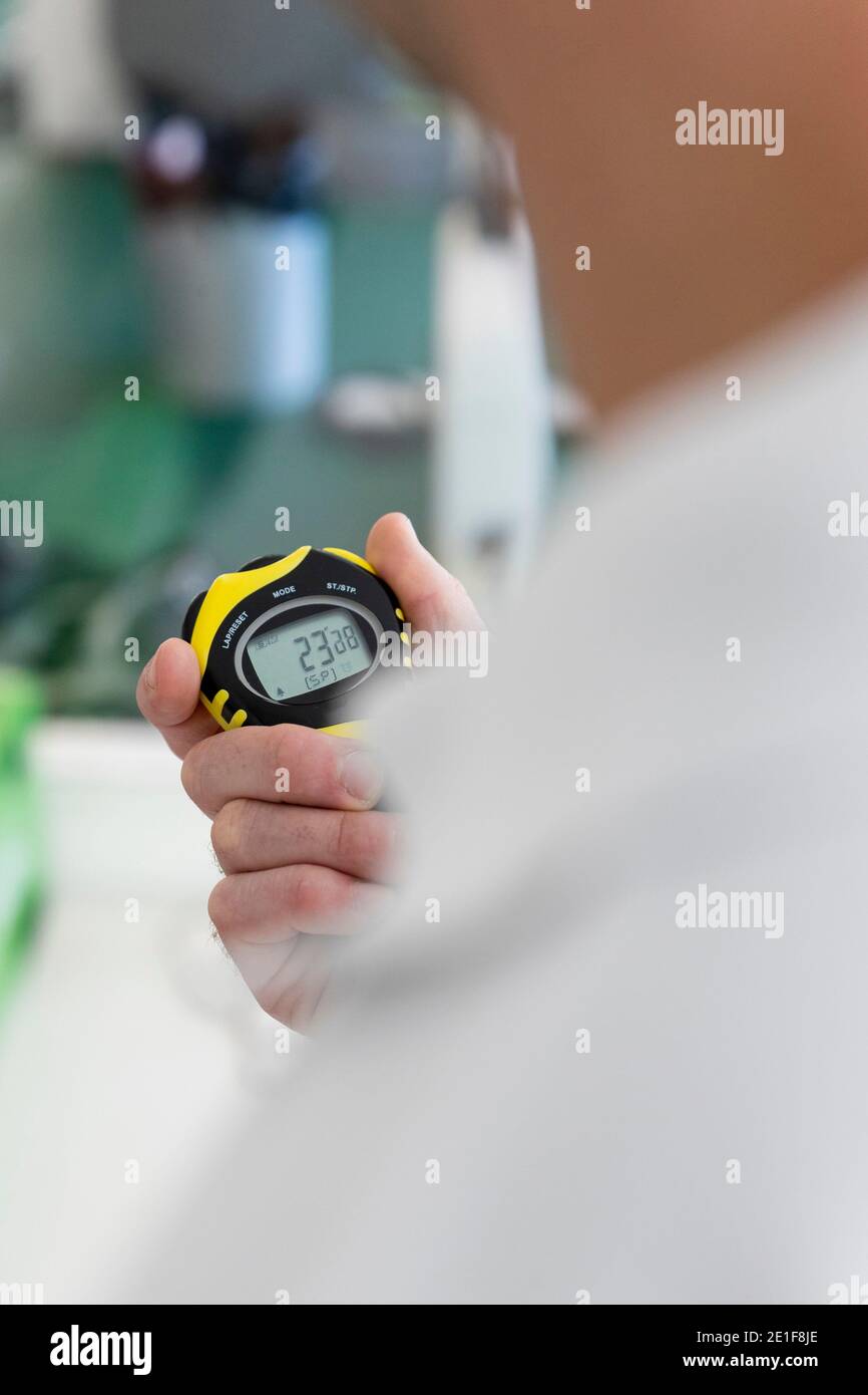 a physical trainer times a physical test, a stopwatch in hand Stock ...