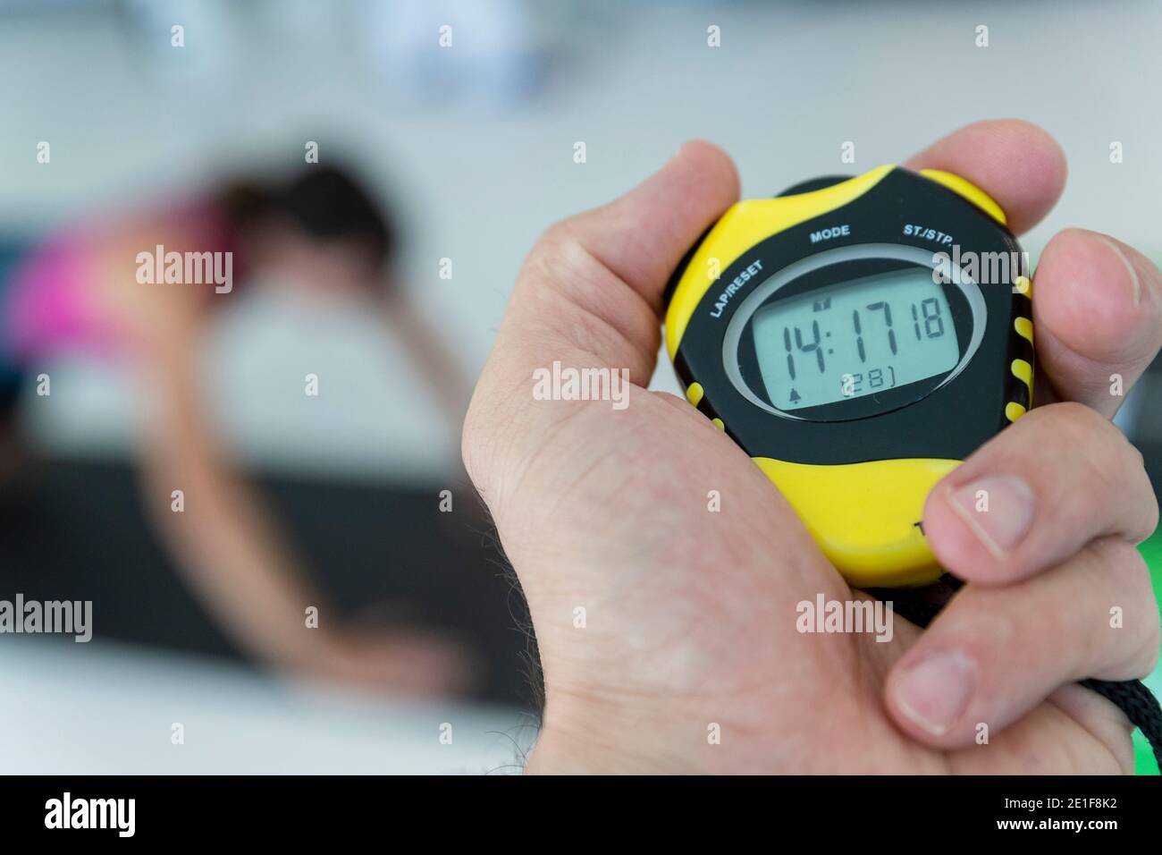 a physical trainer times a physical test, a stopwatch in hand Stock ...