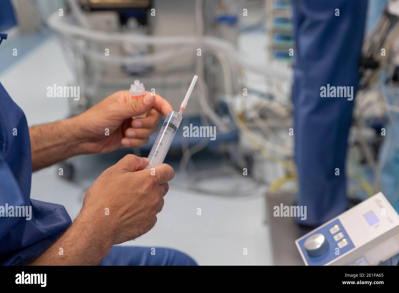 a doctor prepares a syringe during surgery Stock Photo - Alamy