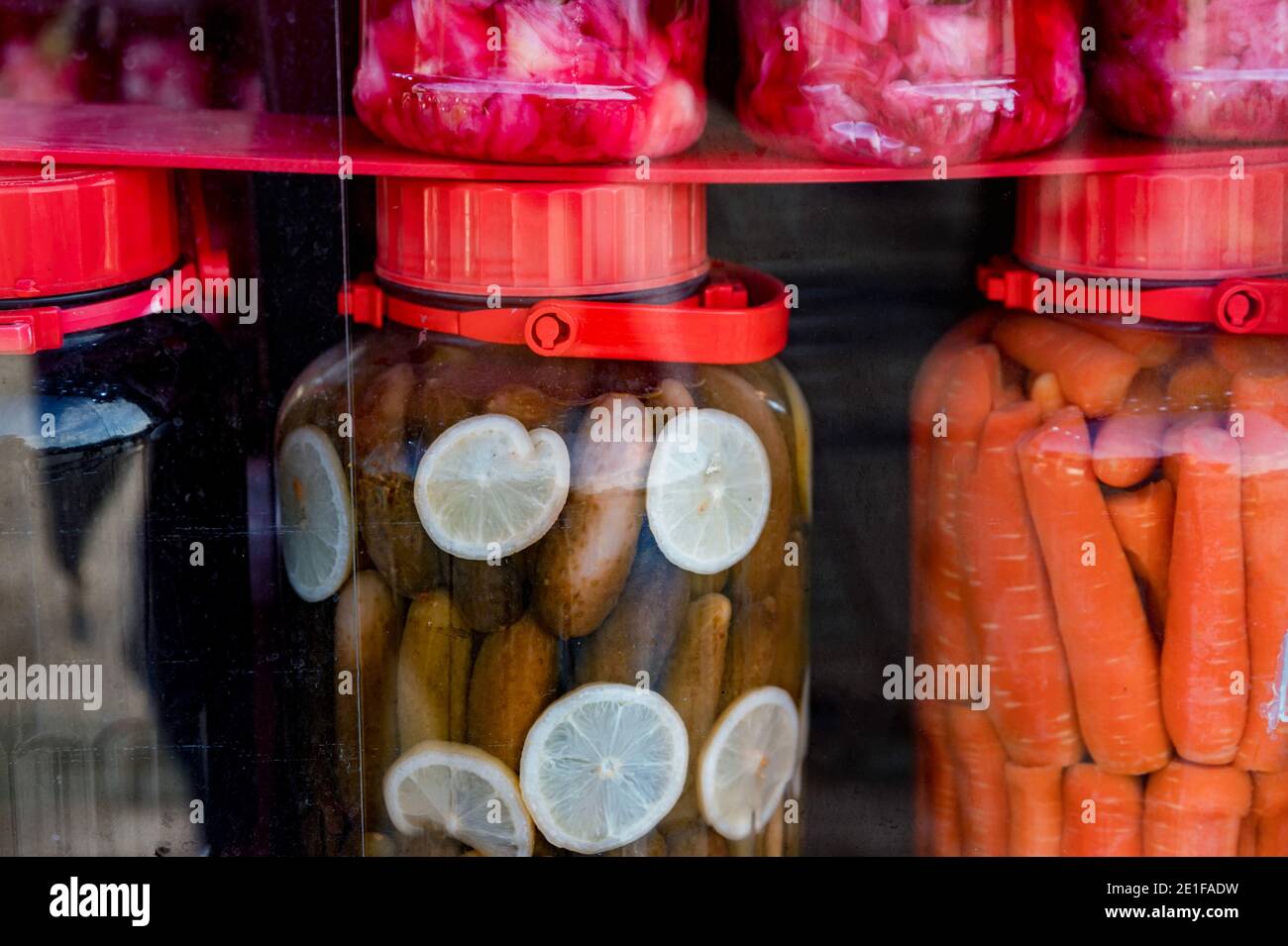 Glass jars with different pickled foods on turkish market. Selective ...