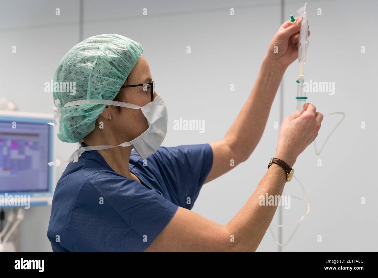 an anesthetist prepares an infusion in the operating room Stock Photo ...