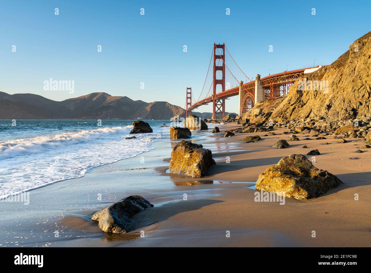Famous Golden Gate Bridge over bay against blue sky, San Francisco, San ...