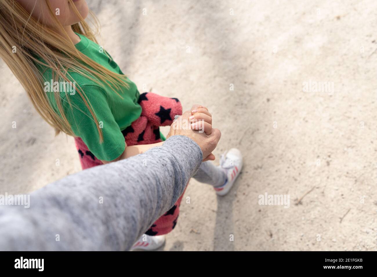 top down view of young blond girl holding hands Stock Photo - Alamy