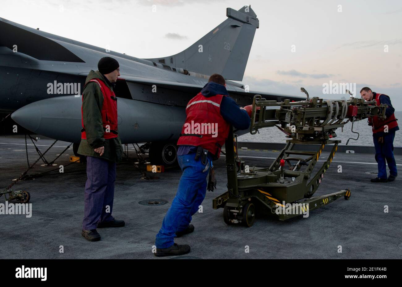 French mecanicians mounting a Mica missile on a Rafale jet fighter in ...
