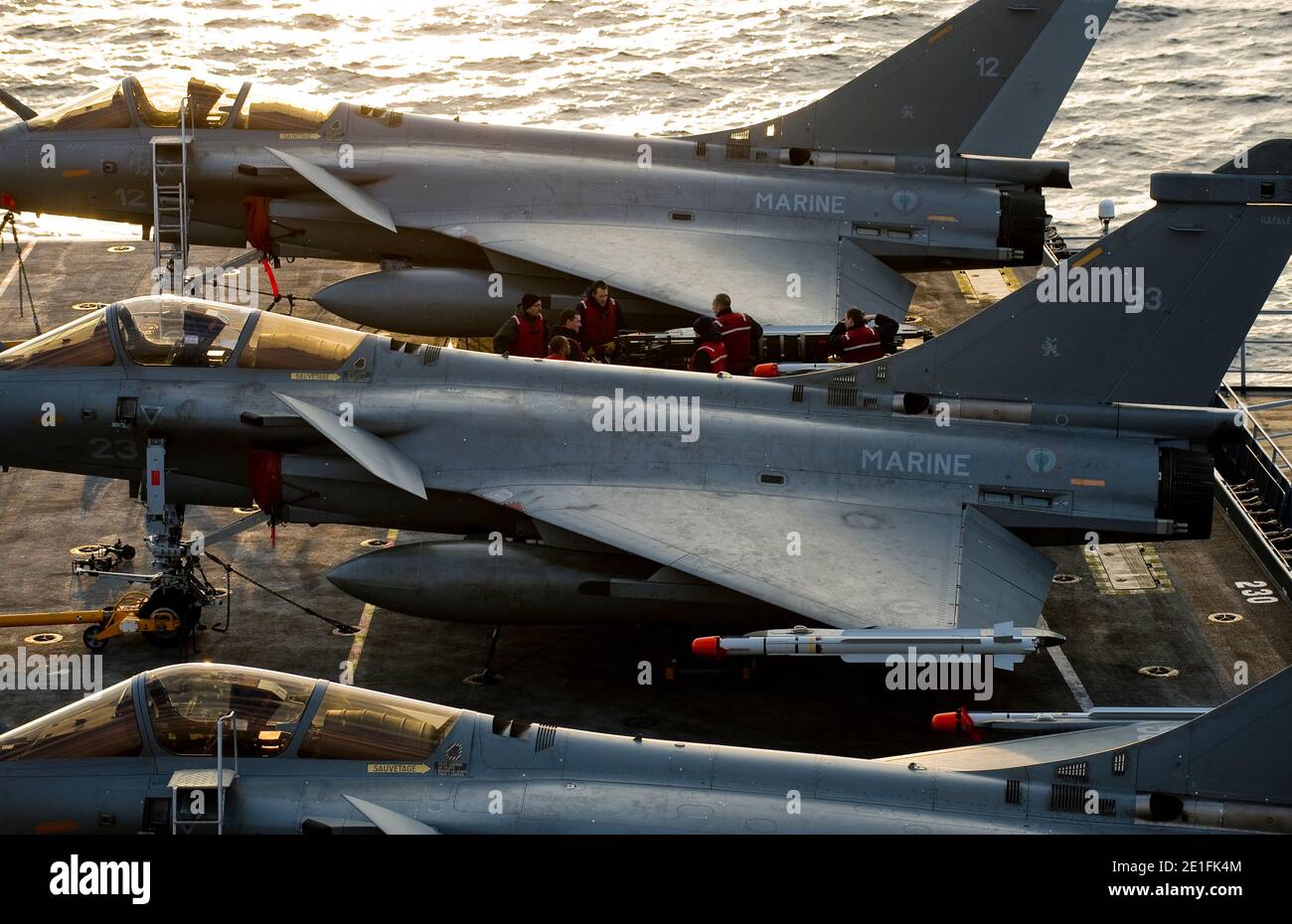 French mecanicians mounting a Mica missile on a Rafale jet fighter in ...