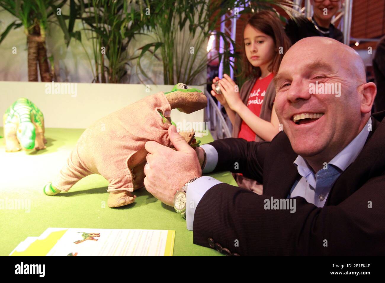 Robopolis Chairman Bruno Bonnell poses with a dinosaur robot at ...