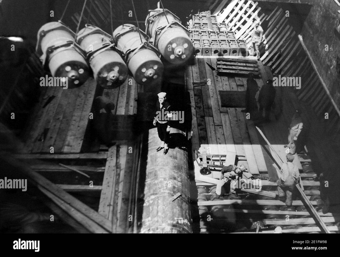 Load of 2,000 pound bombs being loaded into a ship's hold, WWII ...
