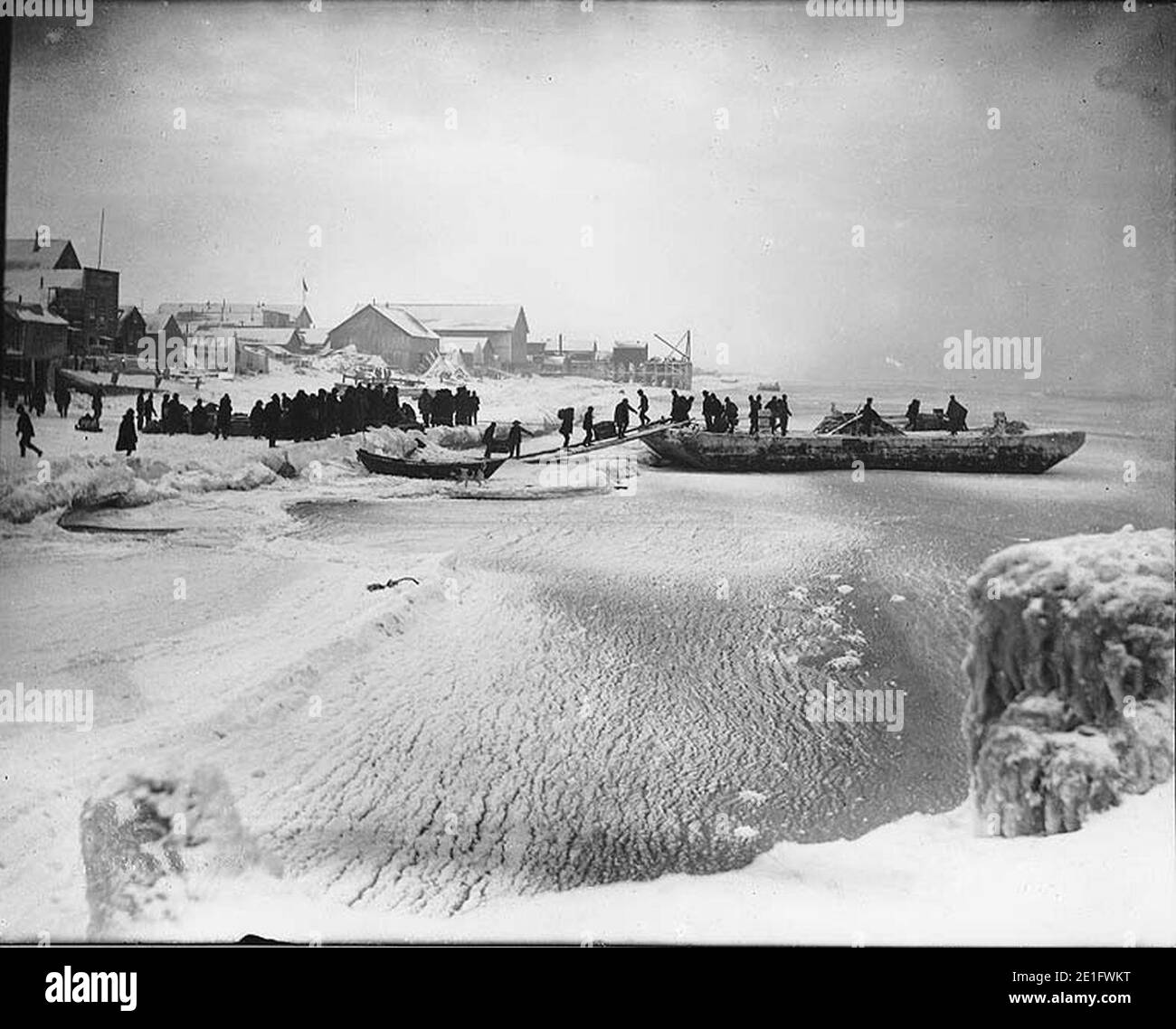 Loading freight and passengers onto lightering scow from the beach ...
