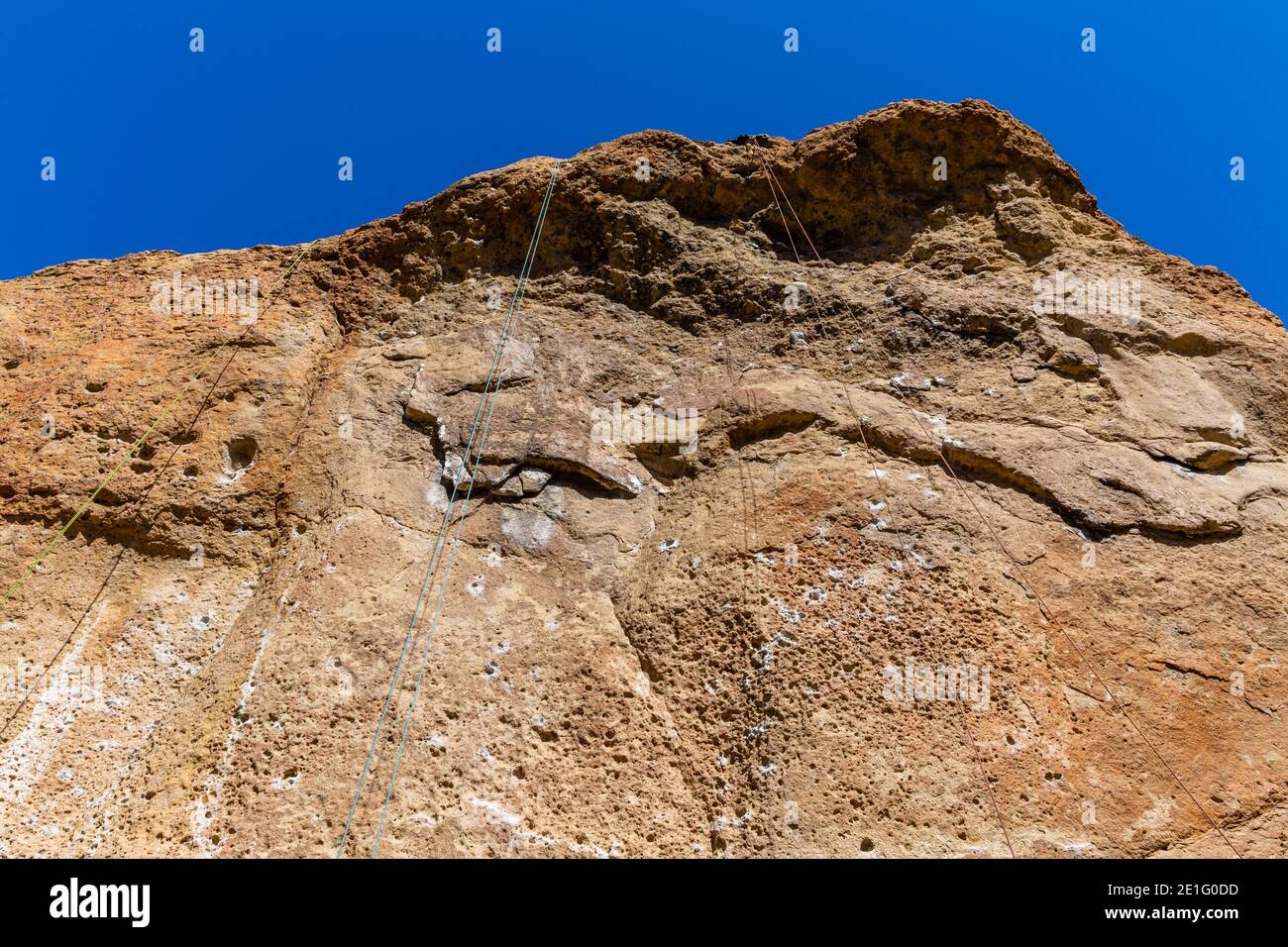 Side of a mountain climbing wall with ropes for repelling Stock Photo ...