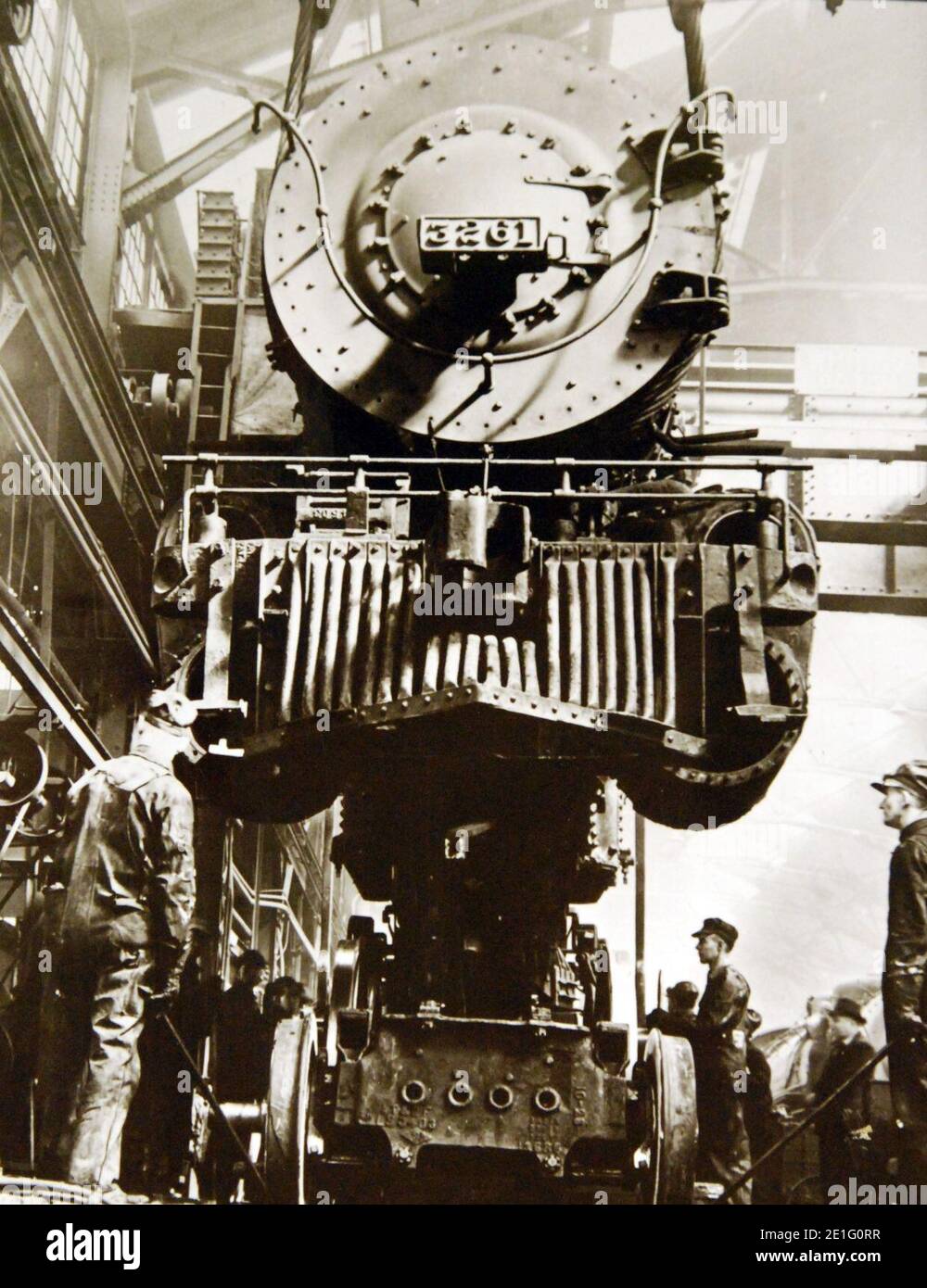Locomotive 3261 is lowered onto wheels in repair shop (34624760471 ...