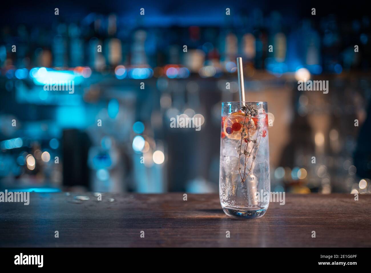 modern gin tonic cocktail with ice, straw and red berries on bar counter Stock Photo - Alamy