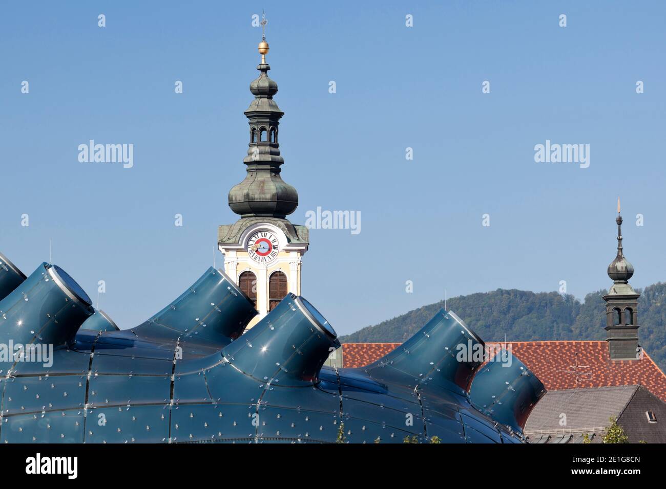 The kunsthaus Graz (2003) with traditional Baroque bell tower, Graz ...