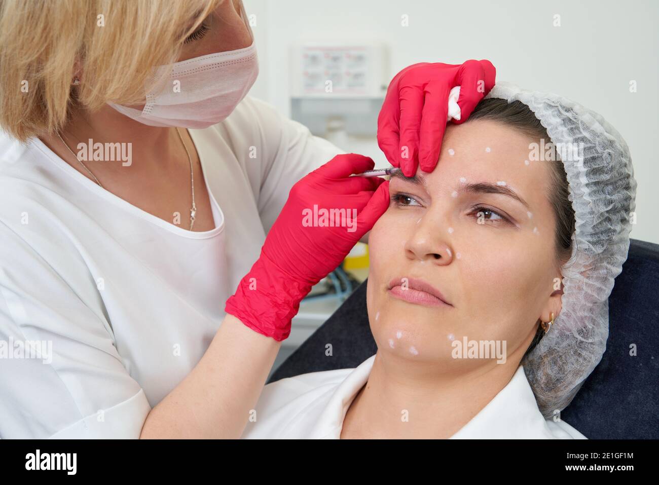 Woman is getting rejuvenating facial injections. The expert beautician ...