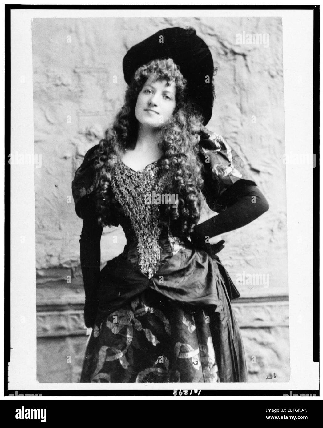 Lottie Collins, three-quarter length portrait, standing, facing left ...