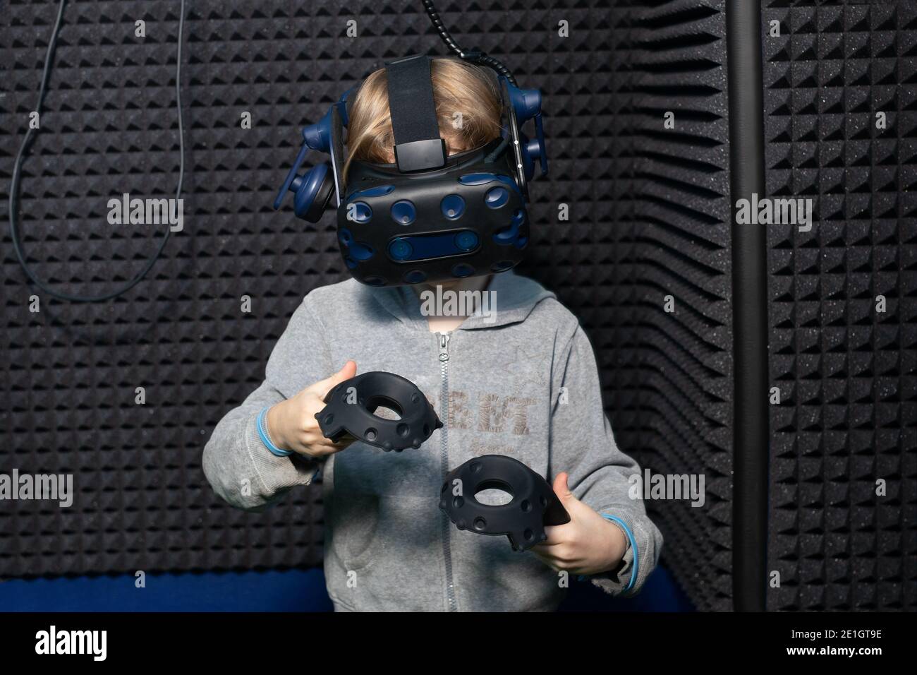 Kid, boy wearing virtual reality headset tries to control 3D world with ...