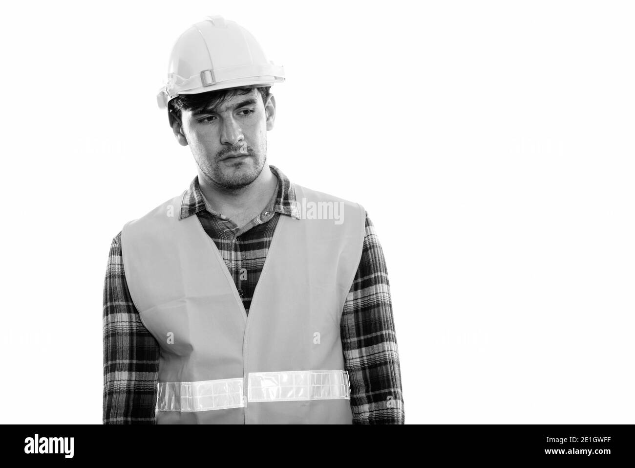 Young Persian man construction worker thinking while looking sad Stock ...
