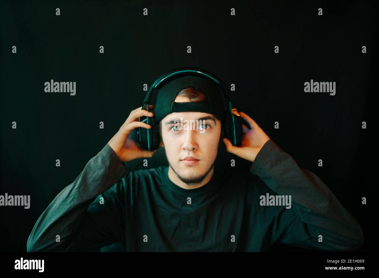 Guy in the cap takes off his headphones. Cyber sport. The person went ...