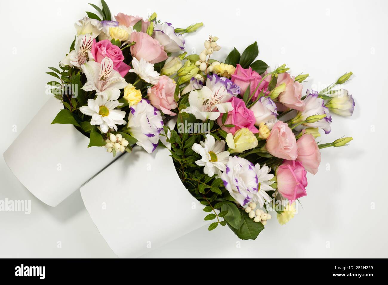 flat lay two bouquets of different sizes of roses, daisies, lisianthus ...