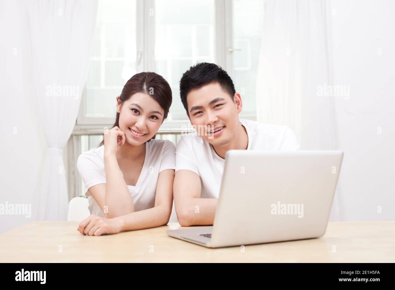 Young Couple Using Laptop at Home high quality photo Stock Photo - Alamy