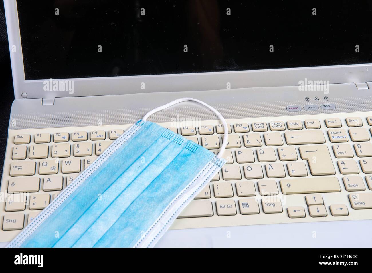 Laptop keyboard with mouth mask bright Stock Photo - Alamy