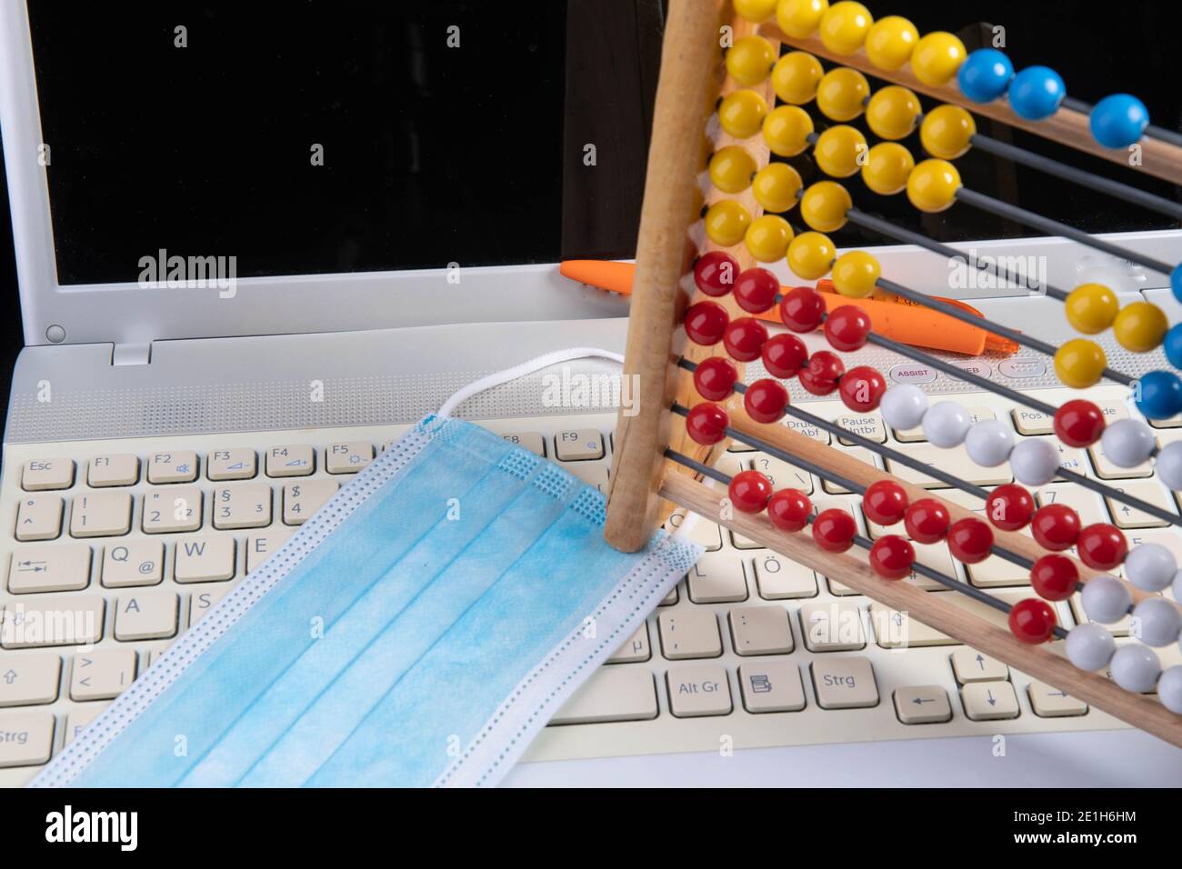 Laptop keyboard with mouth mask and abacus Stock Photo - Alamy