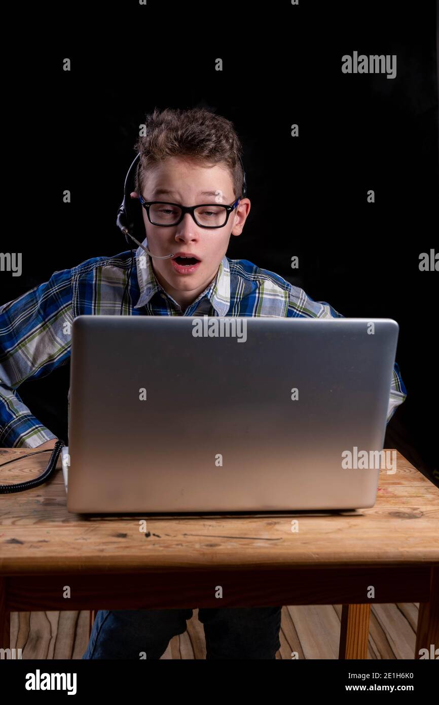 Boy sitting typing laptop indoor hi-res stock photography and images ...