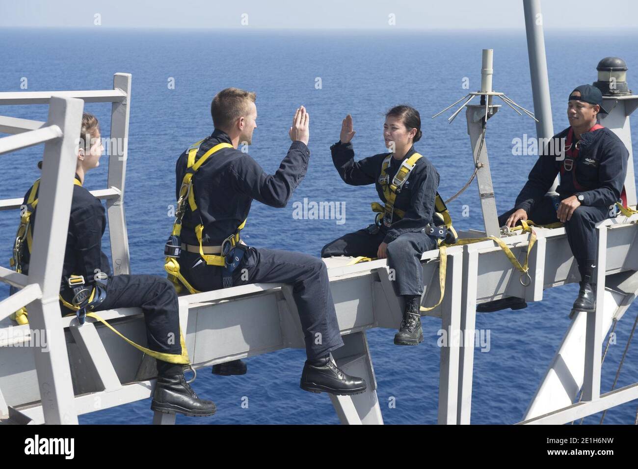 Lt. Cmdr. Ben McCarty reenlists 2nd Class Nikki Duffy on the yardarm of ...